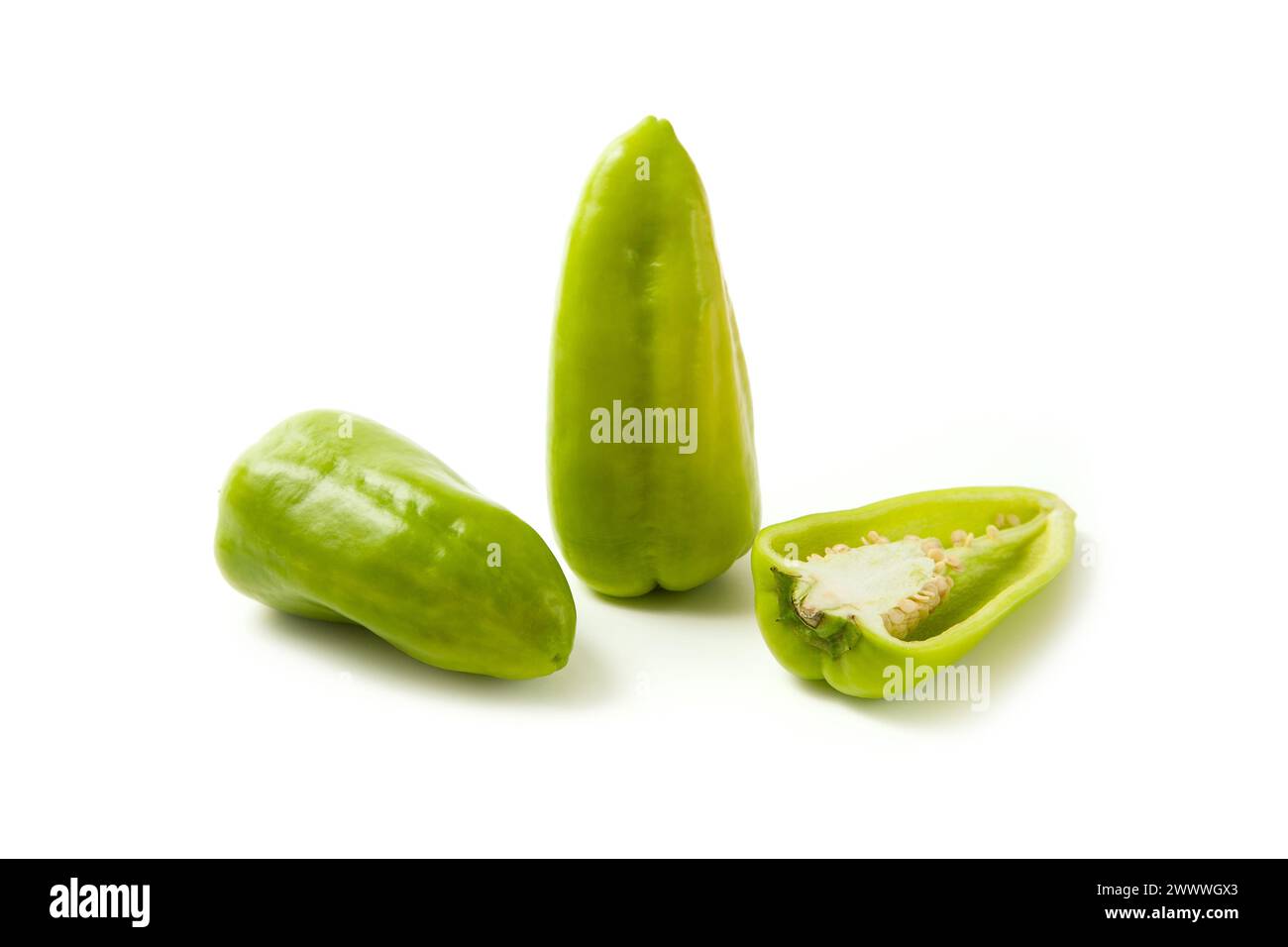 Two whole and half of green bell pepper (capsicum) known as sweet bell ...