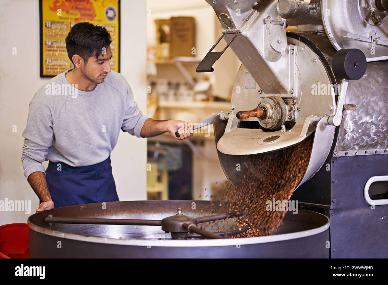 Coffee beans, process and man with machine for roasting with blending ...