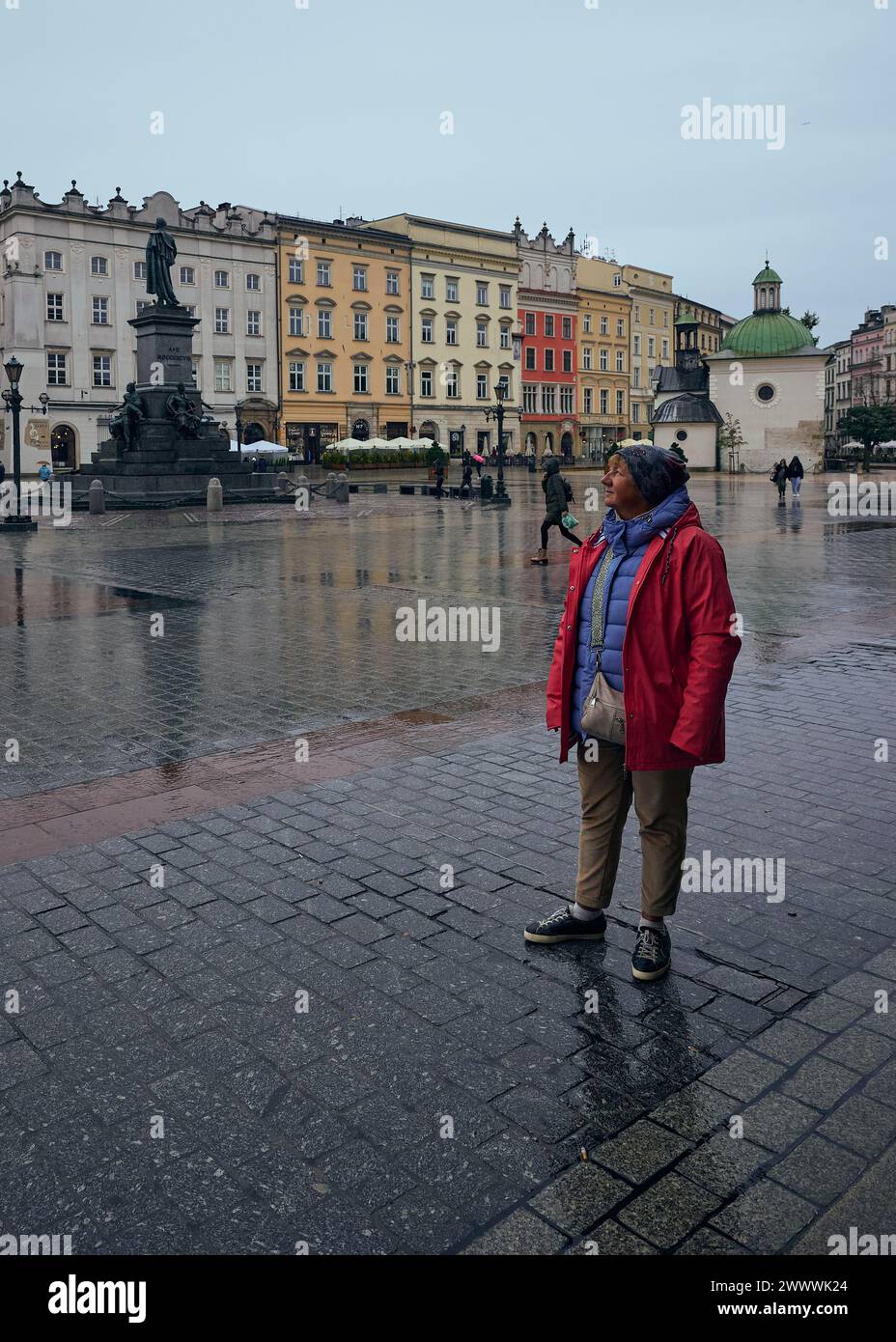 Traveling pretty mature woman on the Market Square at. rainy day ...