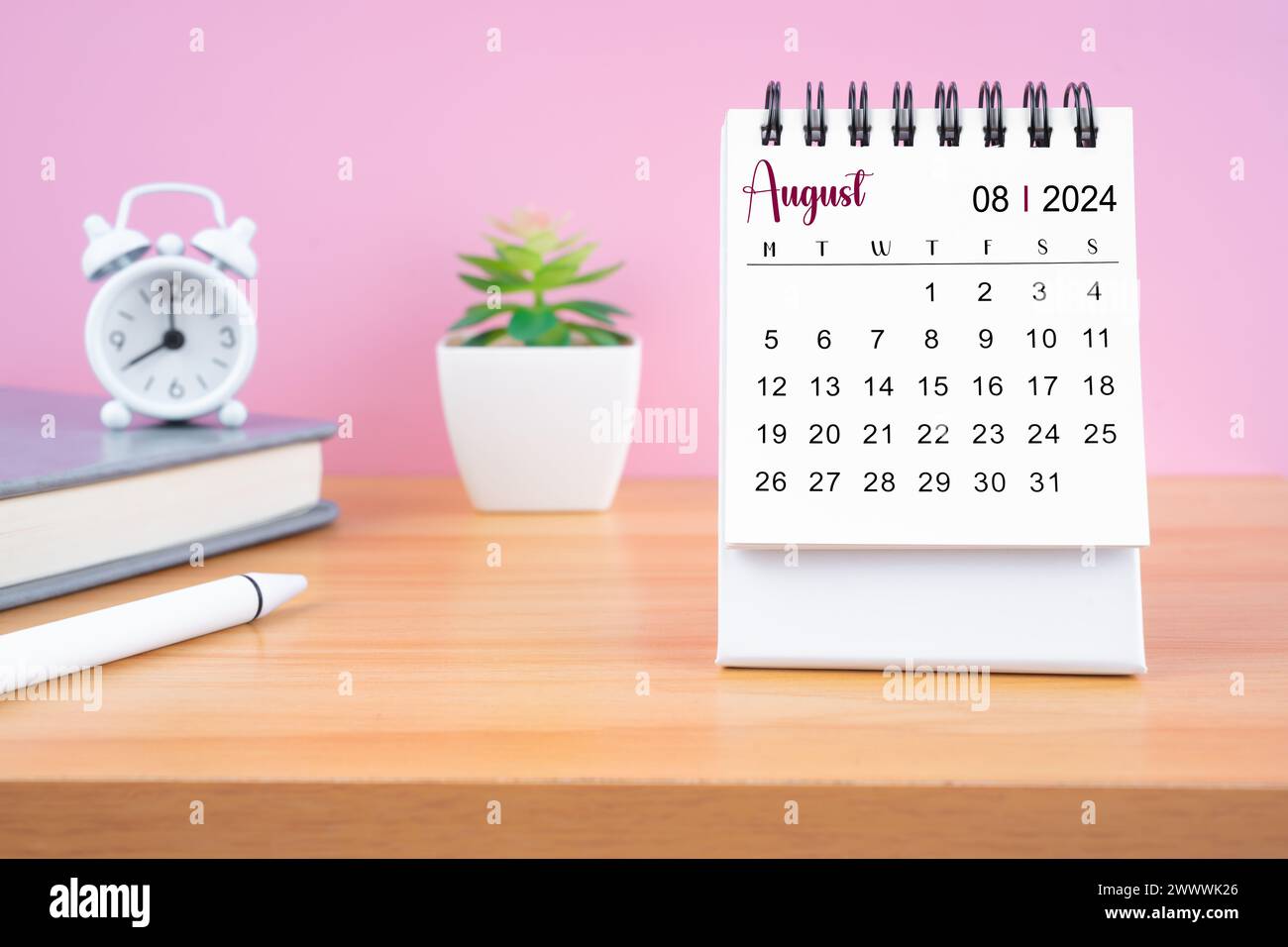 August Mini desk calendar for 2024 year on worktable with pink ...