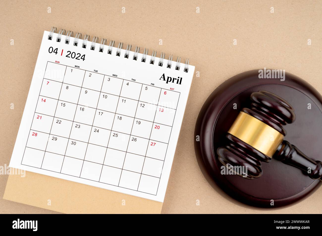 Desk calendar for April 2024 and judge's gavel on brown background ...