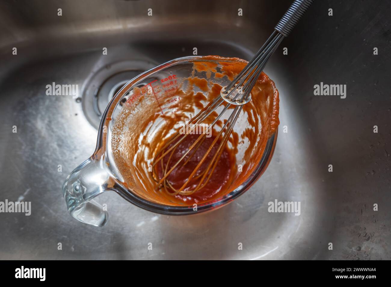 Used filthy measure jar with red sauce leftovers Stock Photo - Alamy