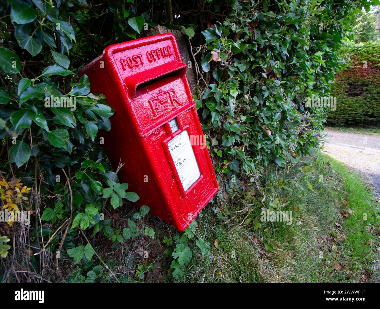 At the side of a country road a bright red British post office letter ...