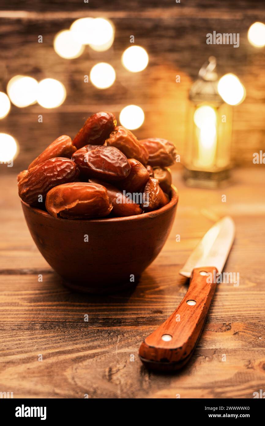 Image of tasty dried dates fruits and knives with arabian light ...