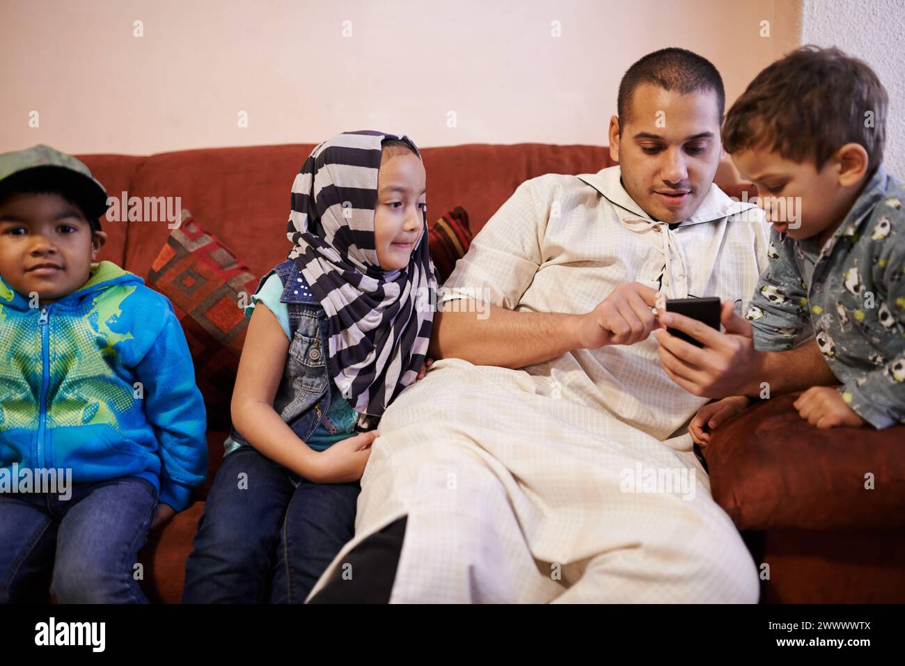 Children, muslim father and mobile in home for playing games, bingo or ...
