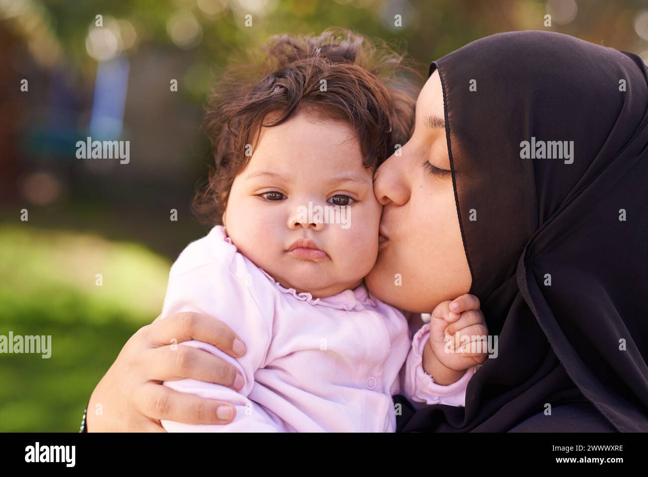 Muslim woman, mother and baby kissing for love, care and bonding during ...