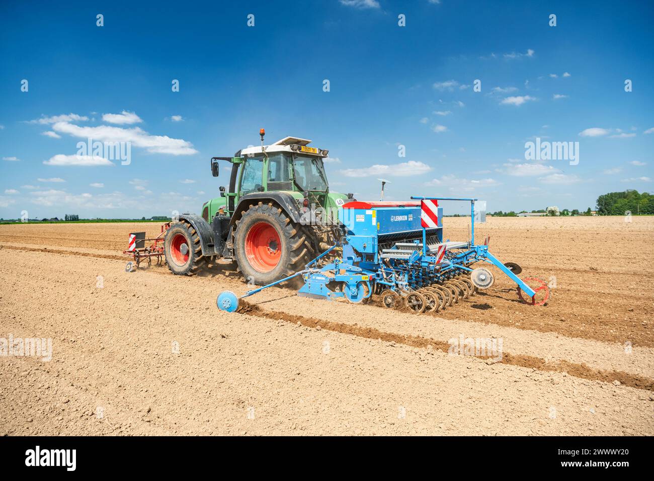 Organic hemp seedling, tractor with Lemken muckspreader Stock Photo - Alamy