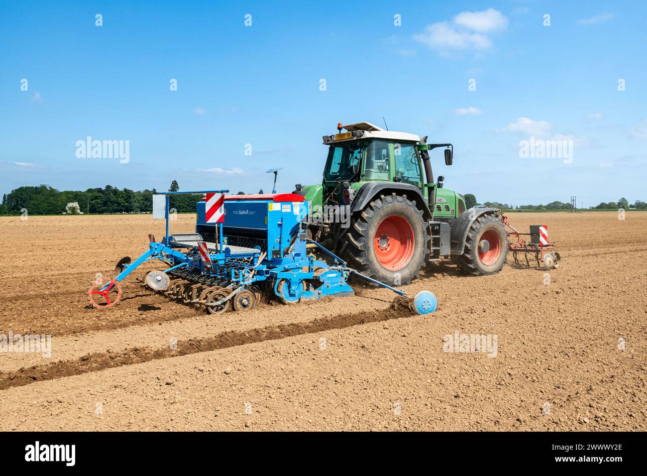 Organic hemp seedling, tractor with Lemken muckspreader Stock Photo - Alamy