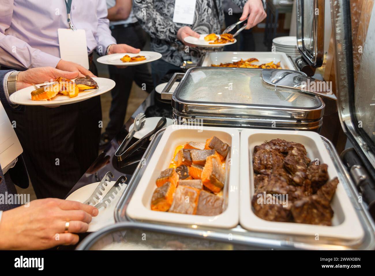 The participants of the business seminar choose food during their lunch ...