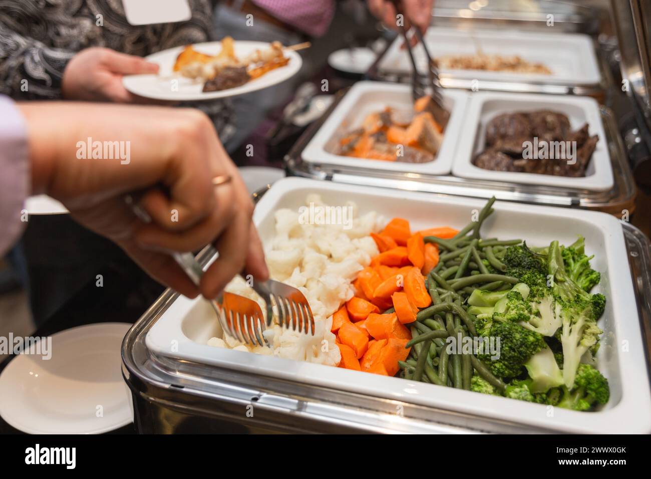 The participants of the business seminar choose food during their lunch ...