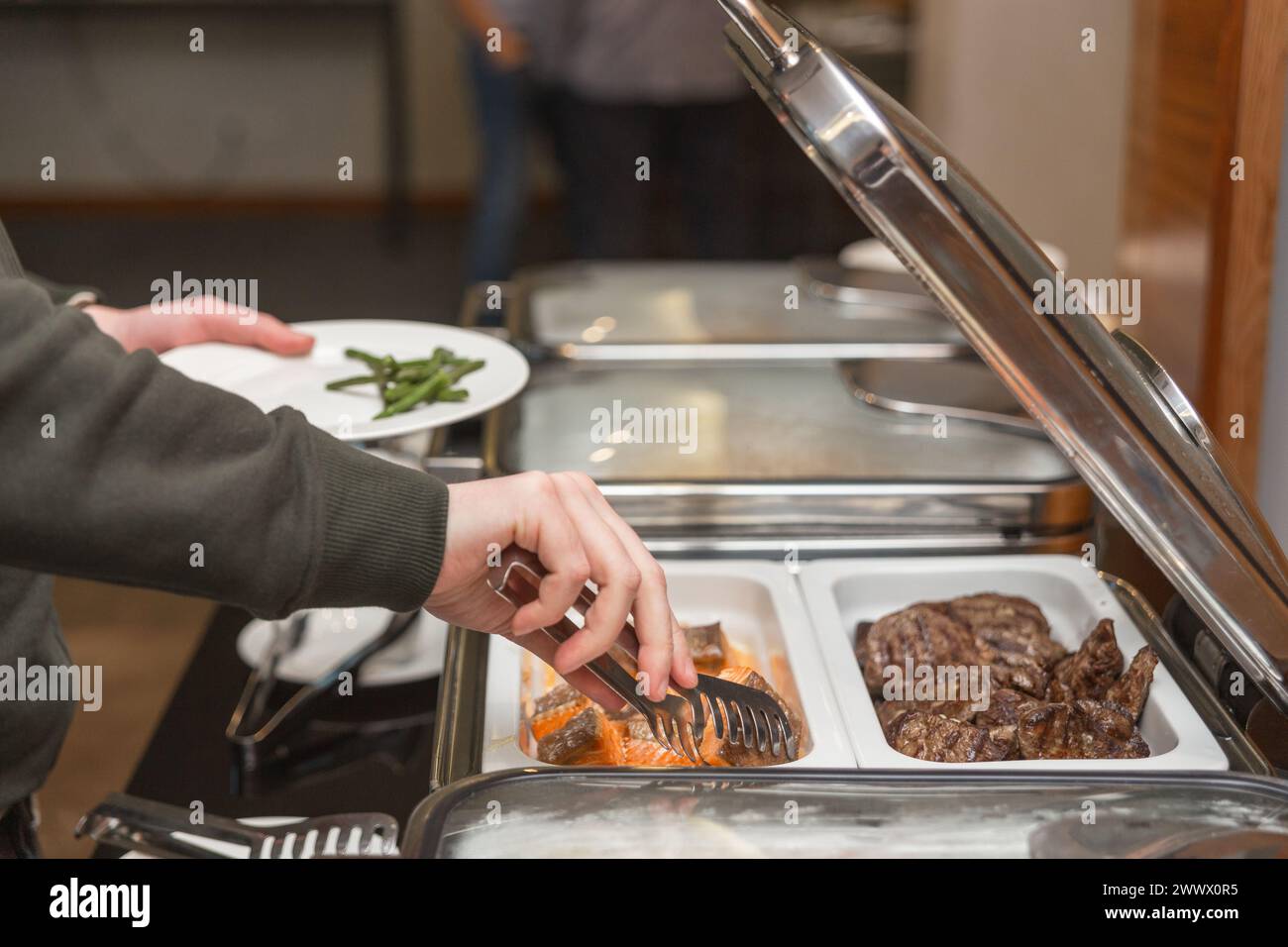 The participants of the business seminar choose food during their lunch ...