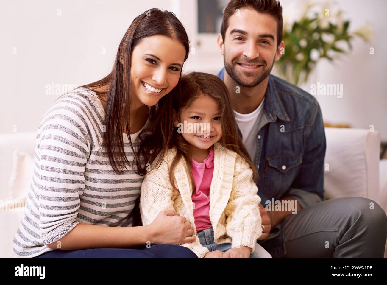 Mother, dad and girl in home for portrait with love or care, smile and ...