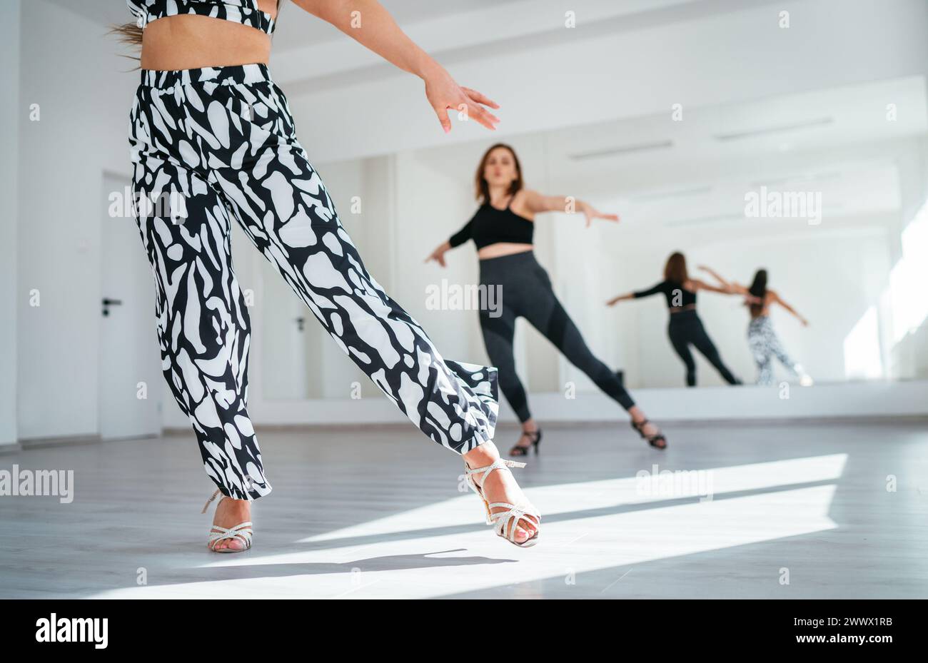 Graceful dancing women group doing elegant dance movements in white ...