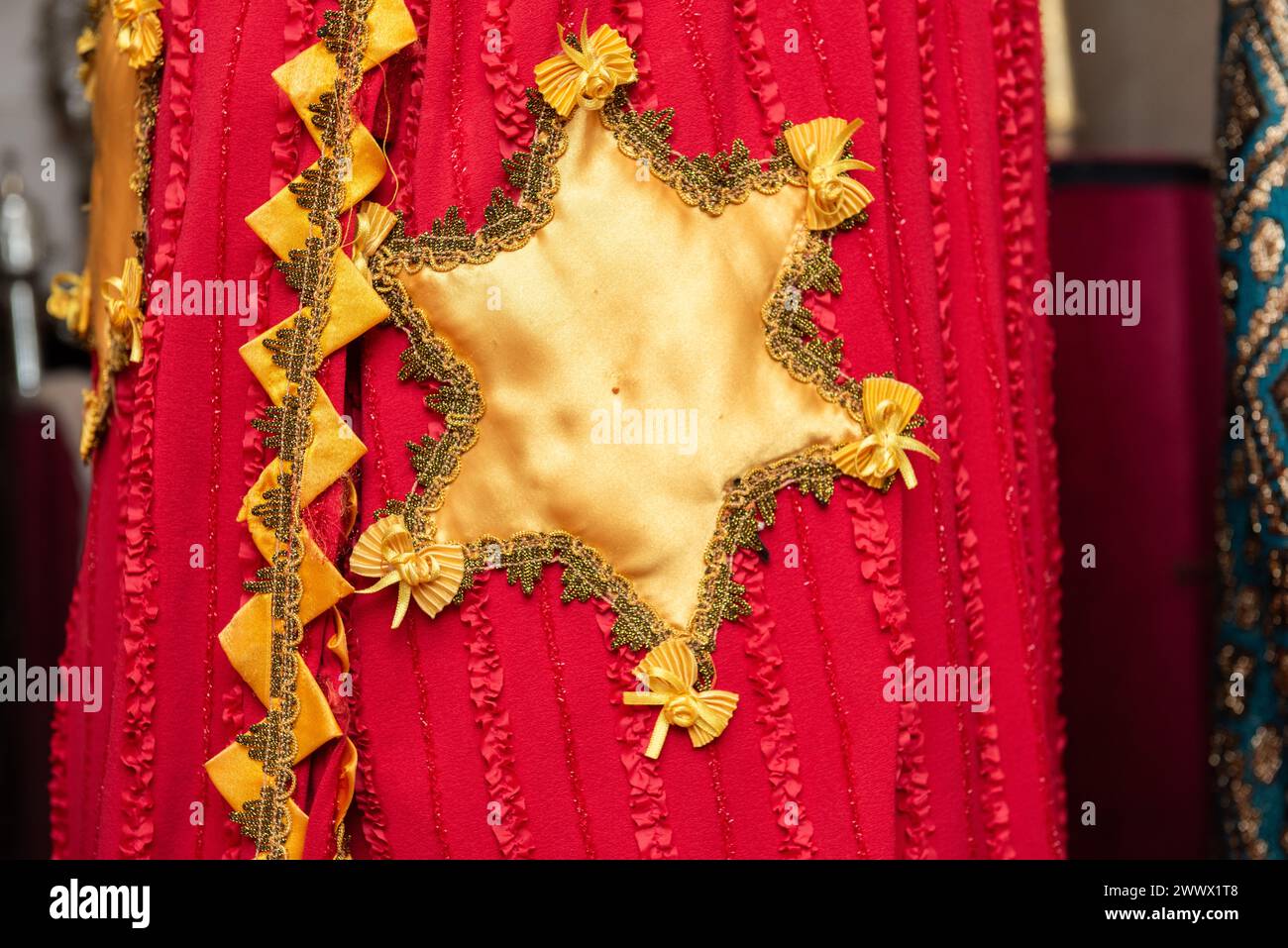 Detail of the covering of a Torah scroll with a red cloth and golden ...