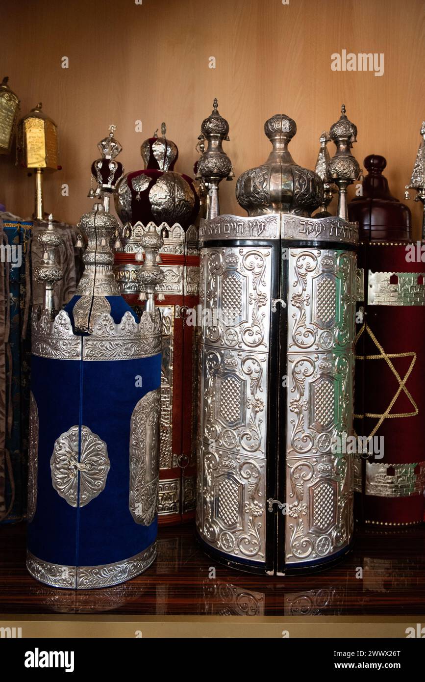 Torah scrolls wrapped in decorative cloth coverings and housed in the ...