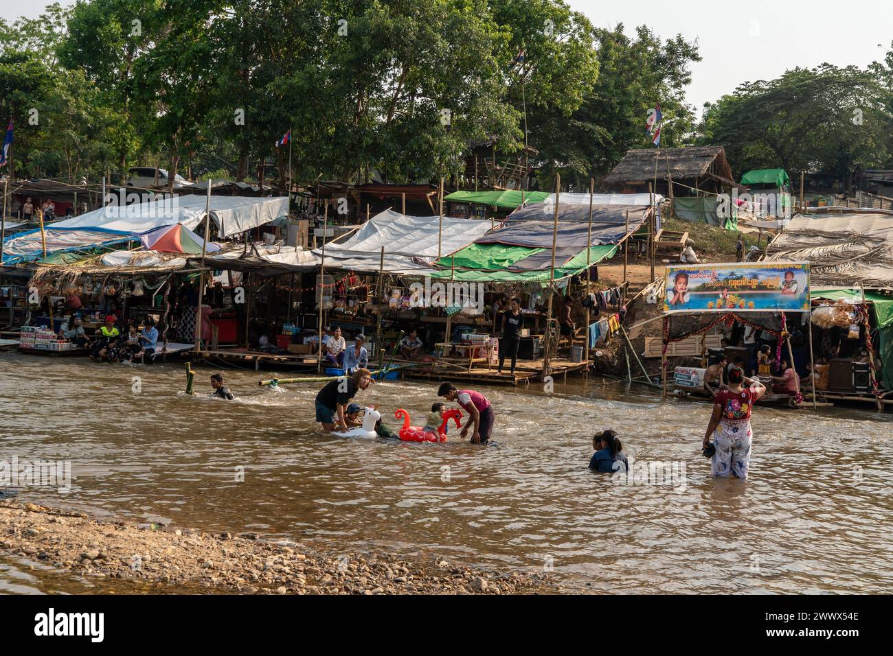 Thai and Burmese families swimming and playing in the Thailand-Myanmar ...