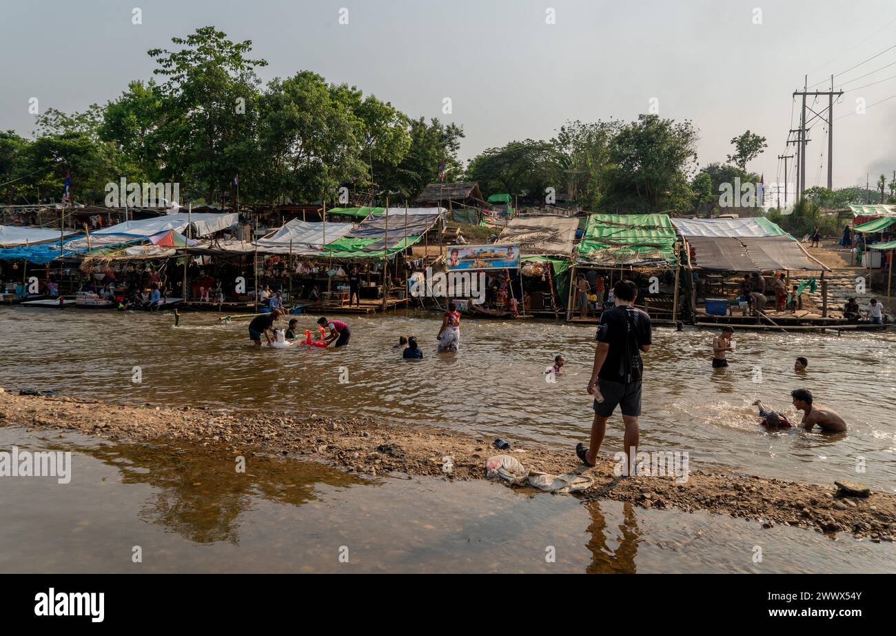 Thai and Burmese families swimming and playing in the Thailand-Myanmar ...