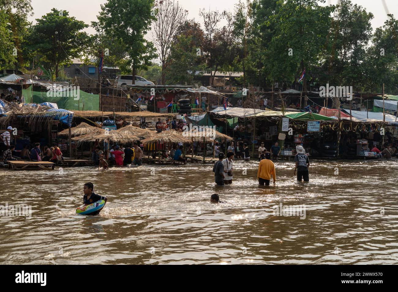 Thai and Burmese families swimming and playing in the Thailand-Myanmar ...