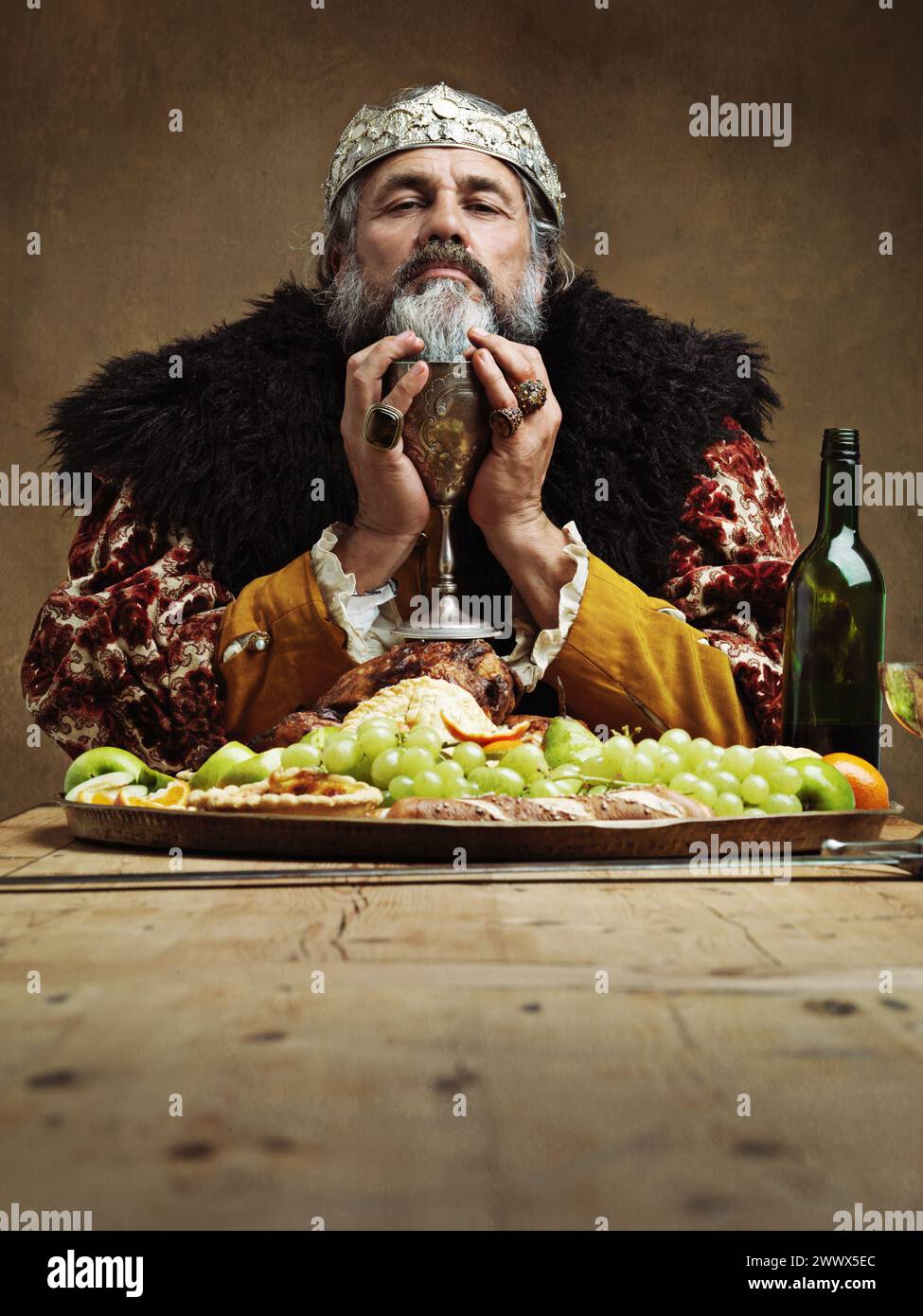 King, feast and wine glass in table as royalty on dining hall for ...