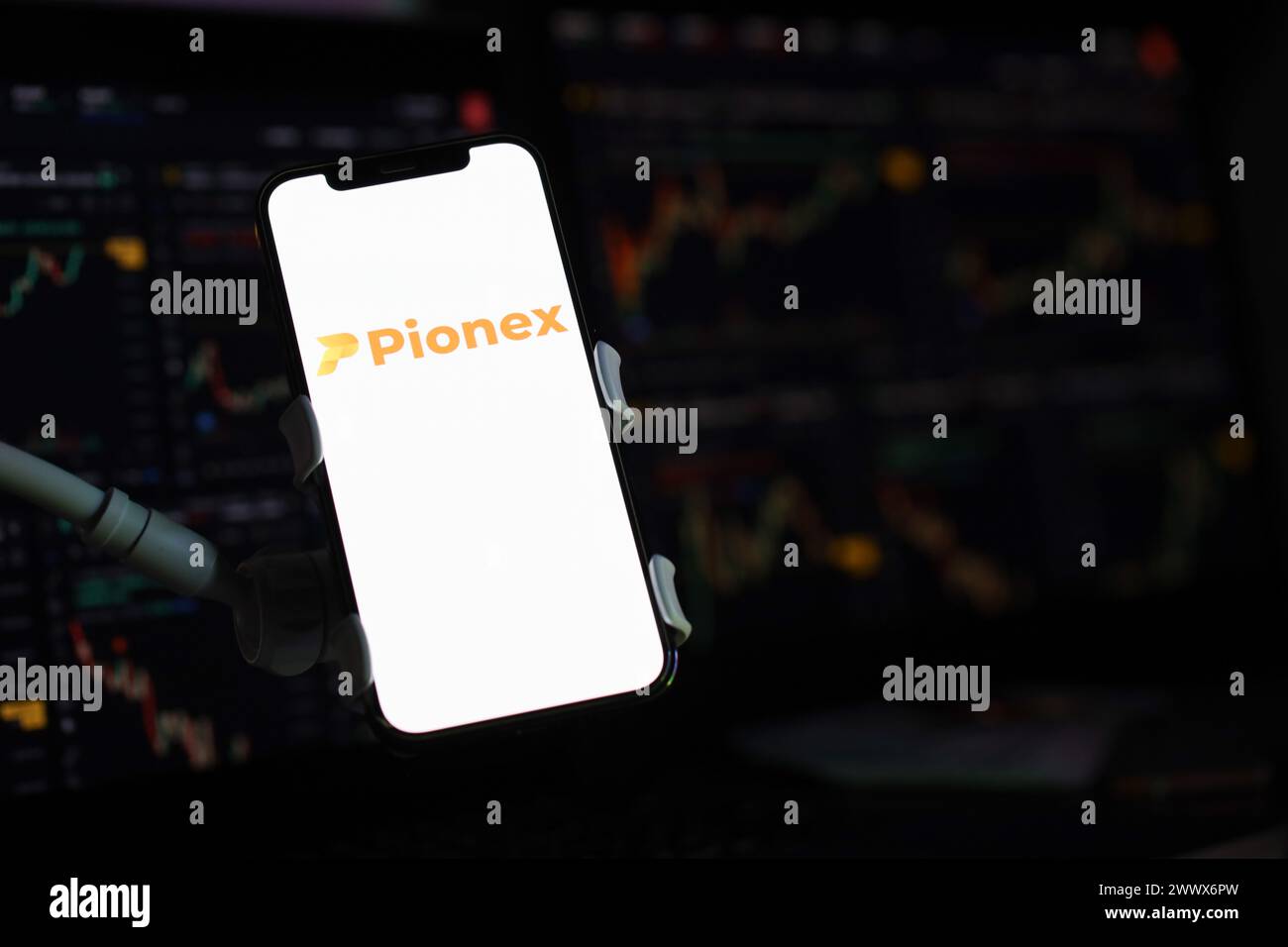 KYIV, UKRAINE - MARCH 15, 2024 Pionex logo on iPhone display screen and ...