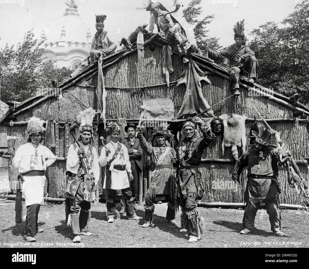 Photograph shows native Americans in traditional dress and one man ...