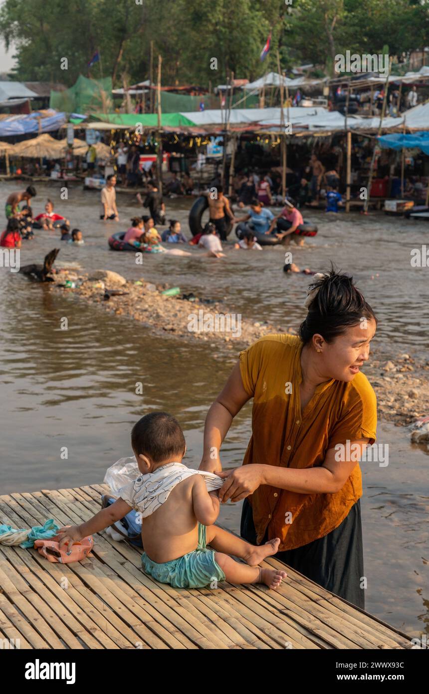 Thai and Burmese families swimming and playing in the Thailand-Myanmar ...