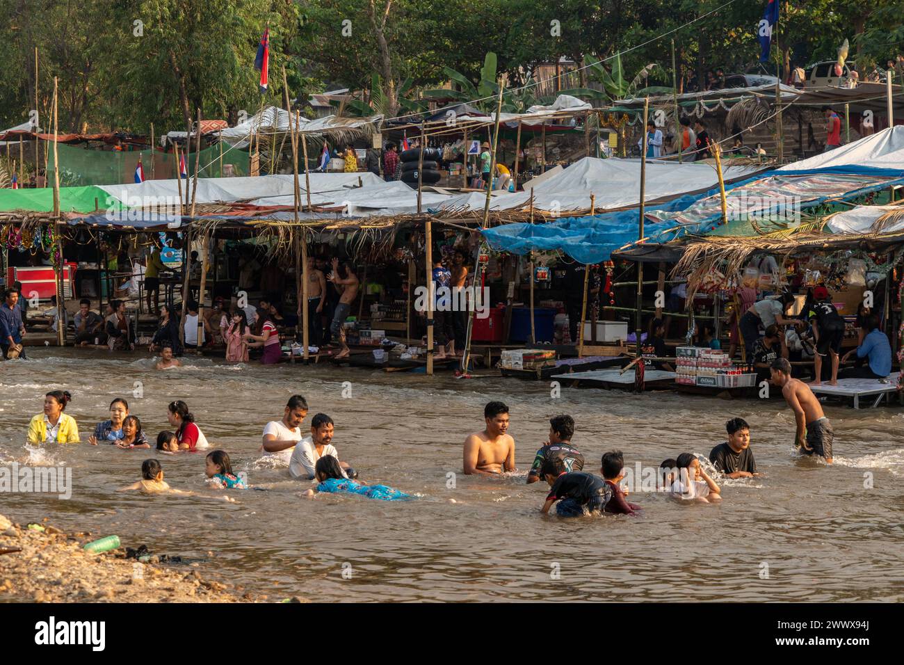 Thai and Burmese families swimming and playing in the Thailand-Myanmar ...