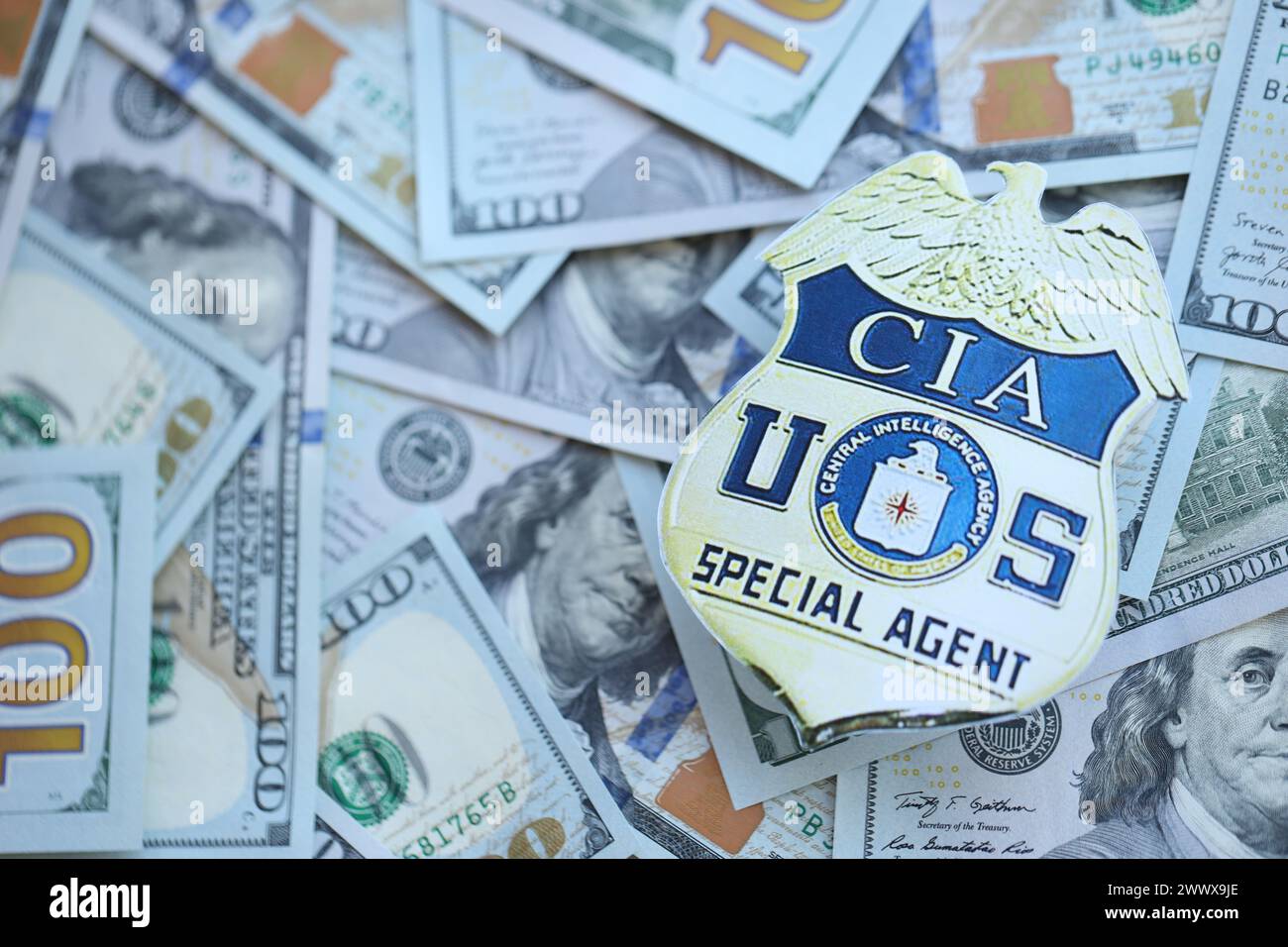 KYIV, UKRAINE - MARCH 9, 2024 US CIA Central Intelligence Agency badge on many US hundred dollar ...