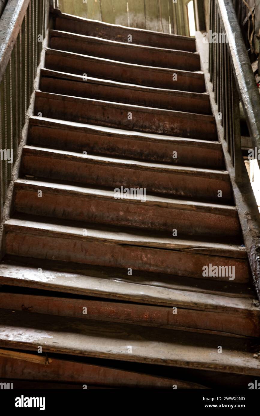 Warped and broken wooden stairway at the entrance to a condemned ...