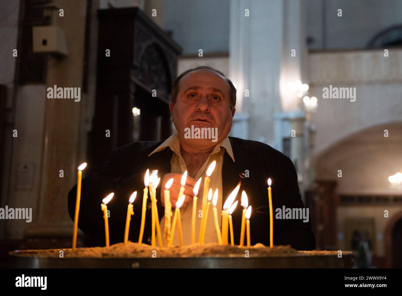 Worshippers light candles and recite prayers in the sanctuary of the ...