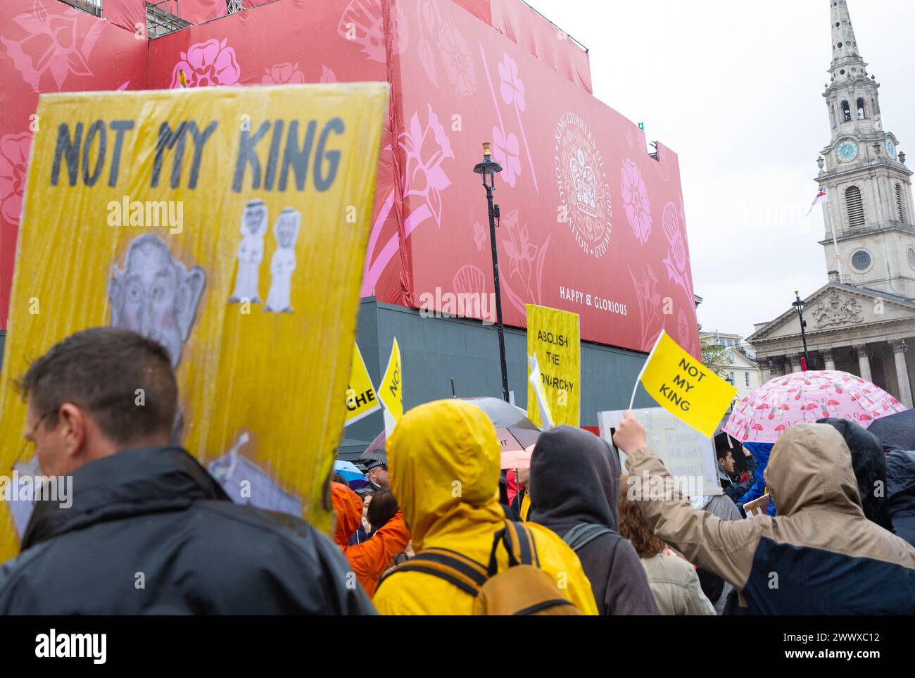 Anti-monarchy placards and posters are held in front of the coronation ...