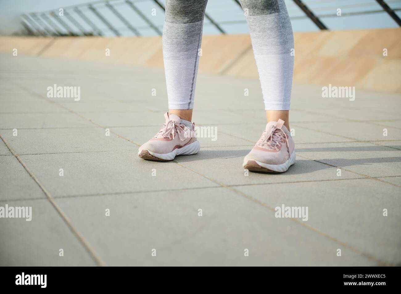 Female runner tying shoes on bridge hi-res stock photography and images ...