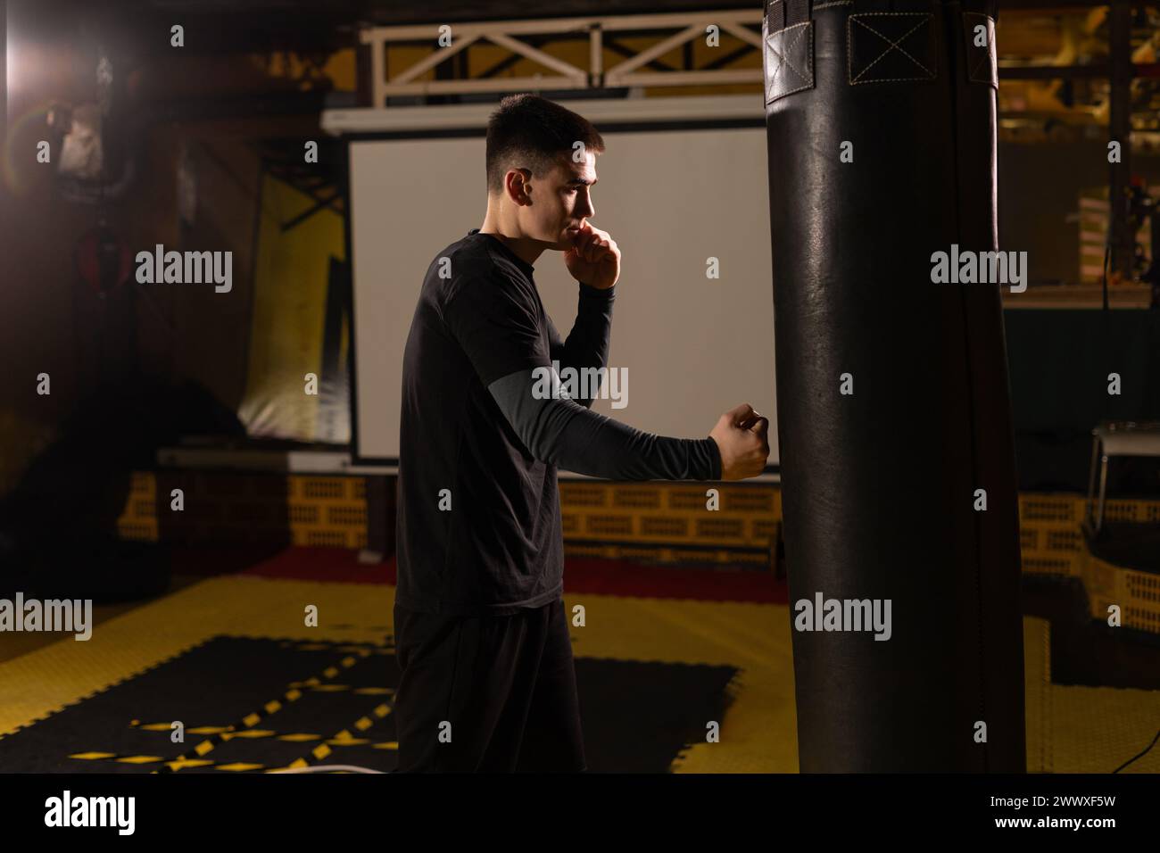 Sportsman boxing in dark gym hi-res stock photography and images - Alamy