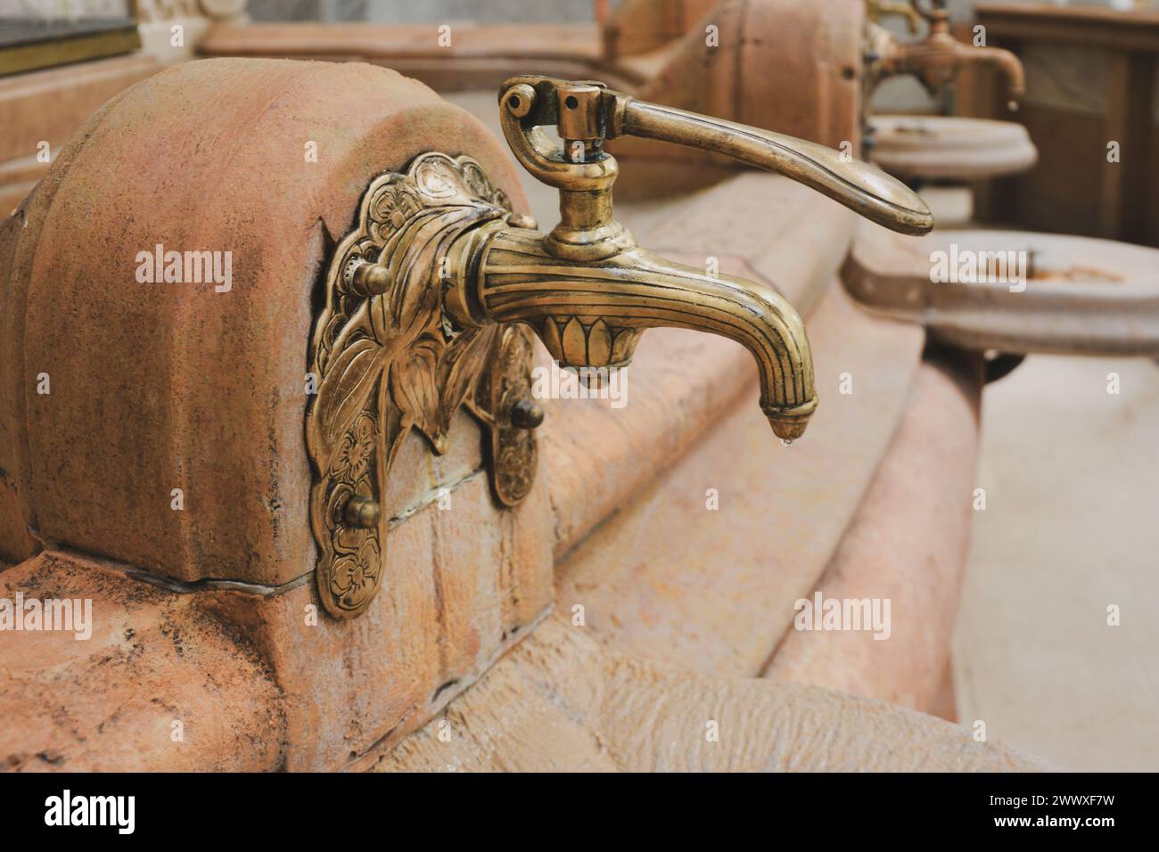 Vintage faucet with a source of mineral water Stock Photo - Alamy