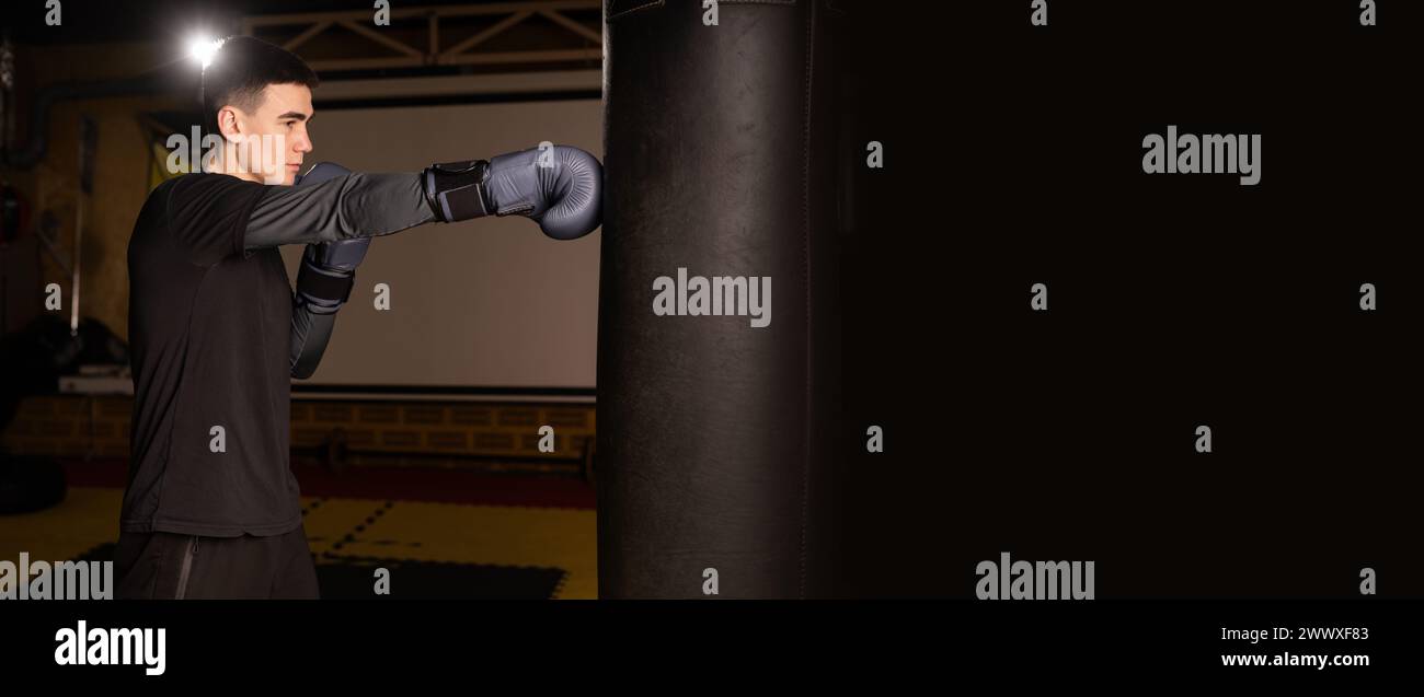 male boxer punching in fierce boxing training session, showcasing Thai ...