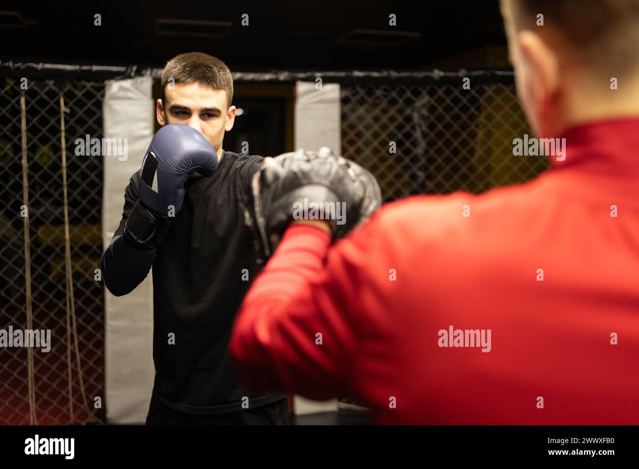 Two professional boxer boxing in dark gym. Boxer training concept Stock ...