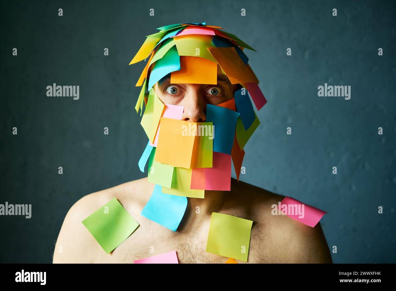 Shocked amazed man with colorful sticky notes all over his face and ...