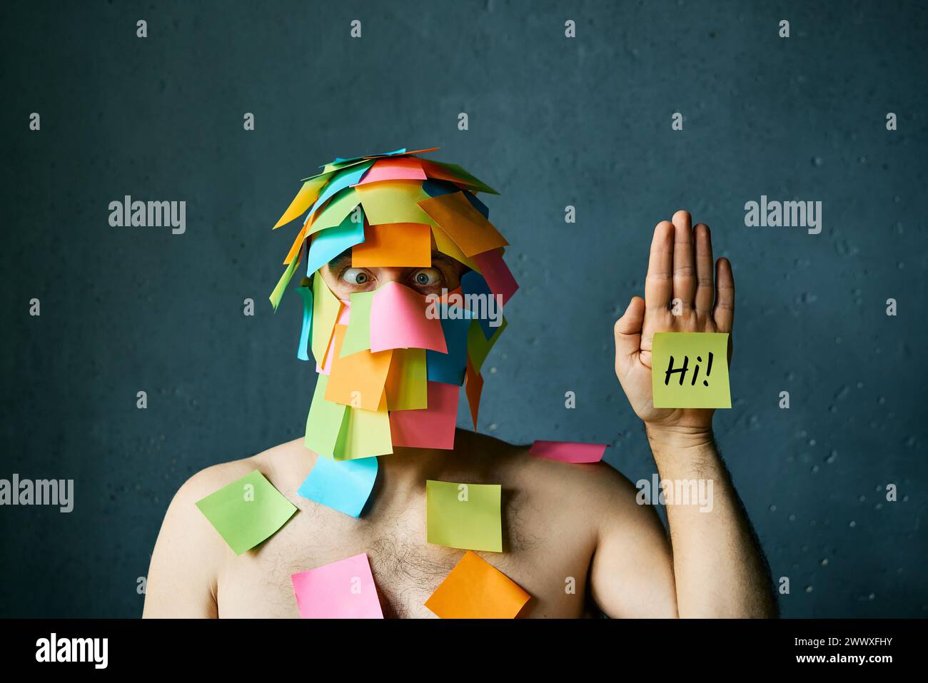 Funny man with cross-eyed covered with colorful sticky notes all over ...