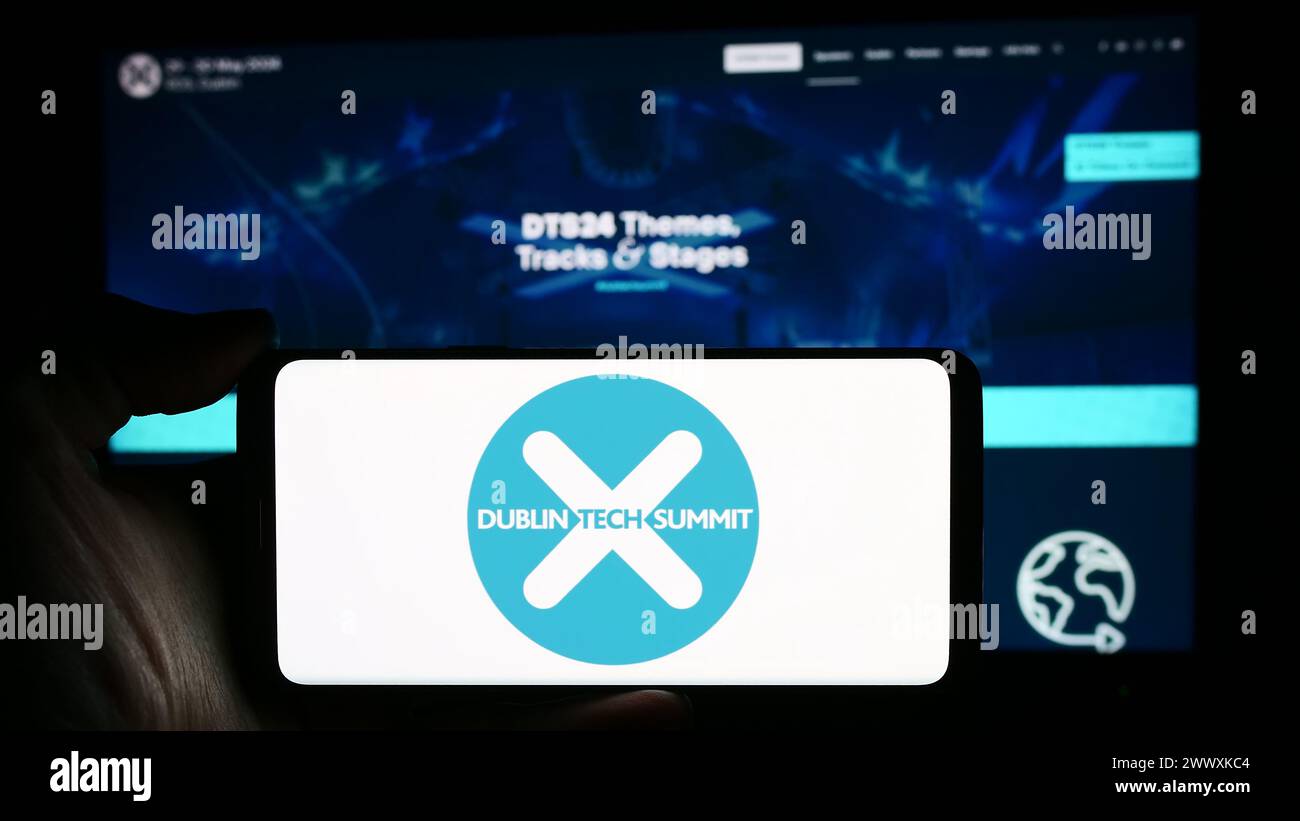 Person holding cellphone with logo of technology conference Dublin Tech ...