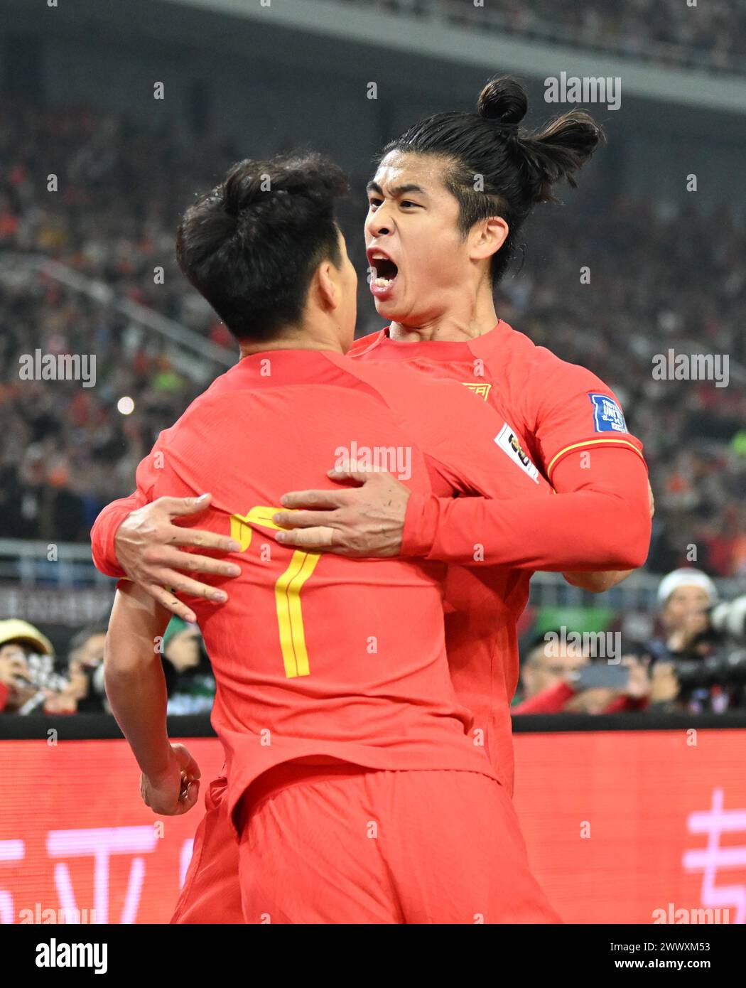 Tianjin. 26th Mar, 2024. Wu Lei (L) of China celebrates scoring with ...