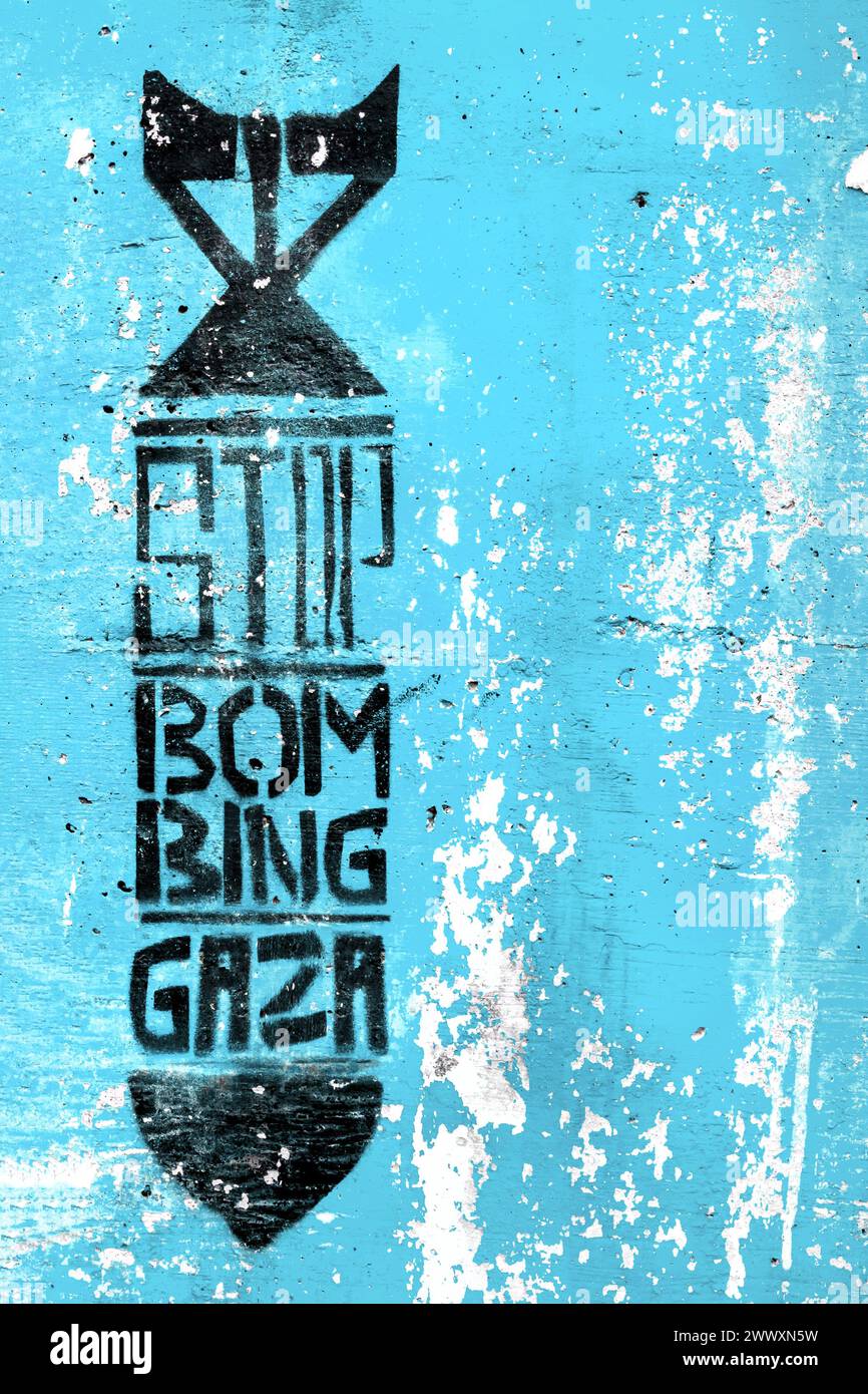 Graffiti on the vintage blue wall depicting the silhouette of a bomb ...