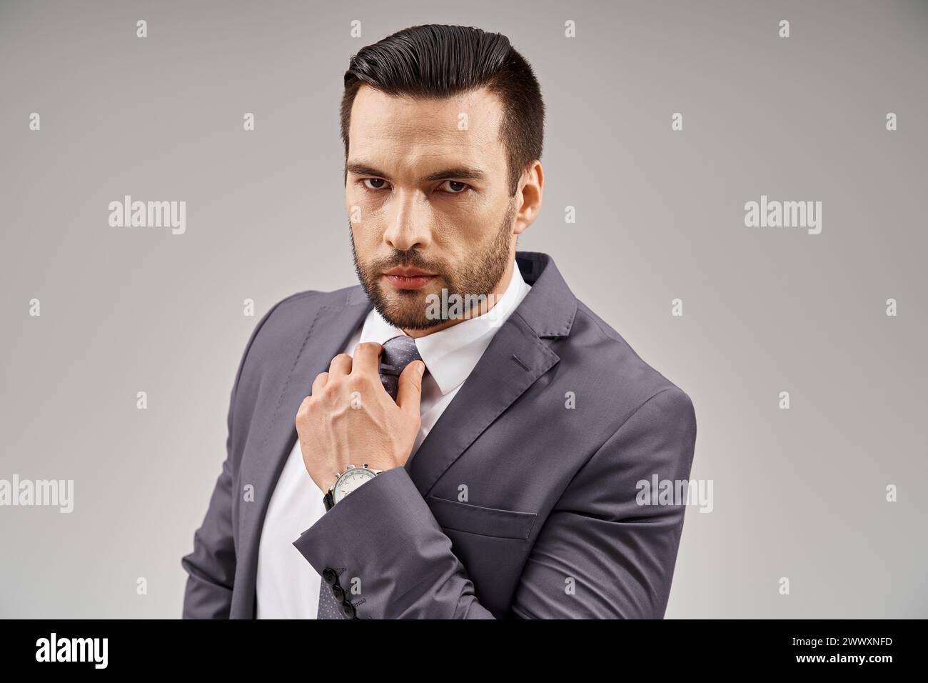 intense gaze from a handsome businessman with bristle posing in a sharp ...
