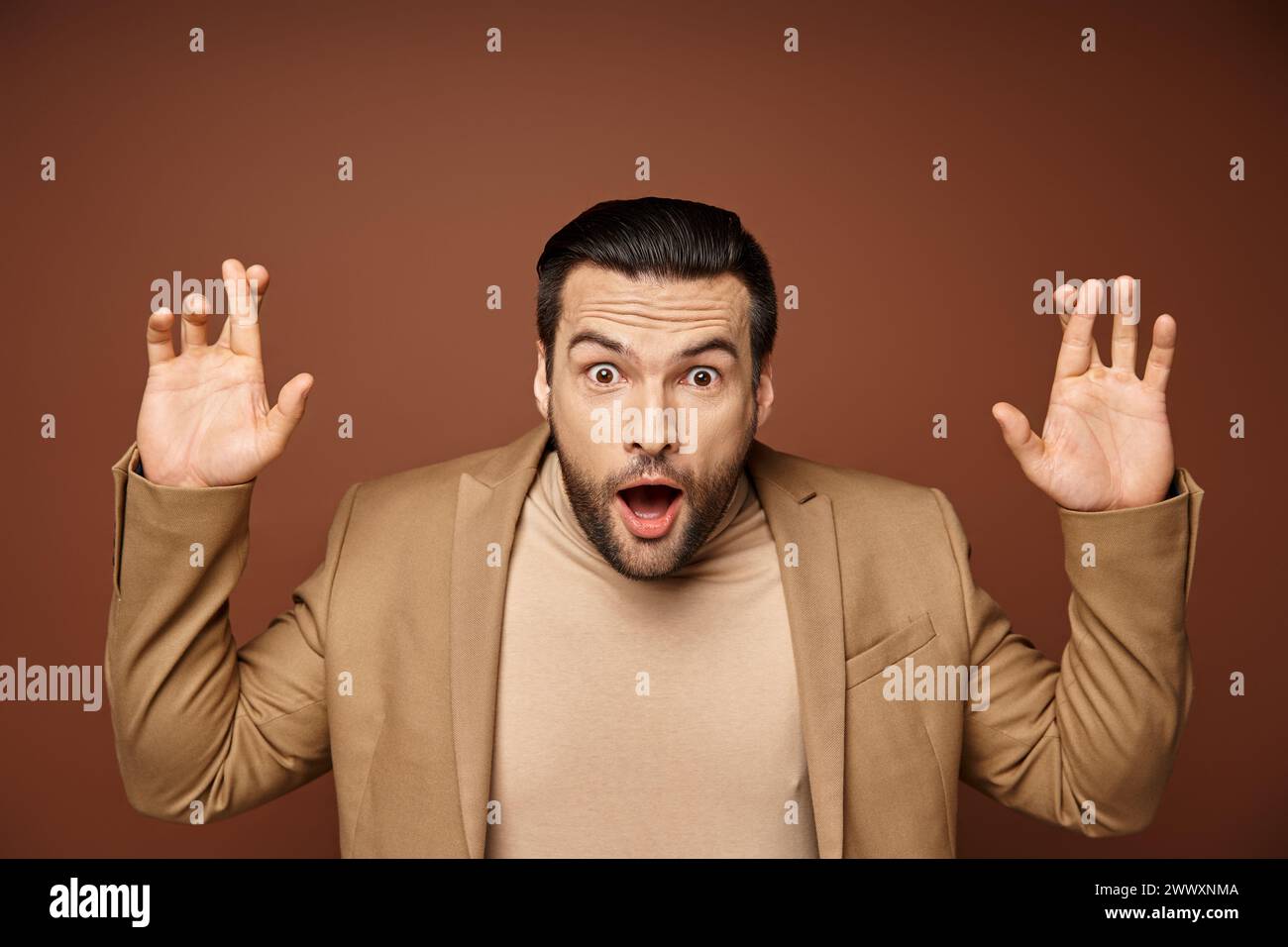 astonished man in elegant attire with his fingers crossed showing ...