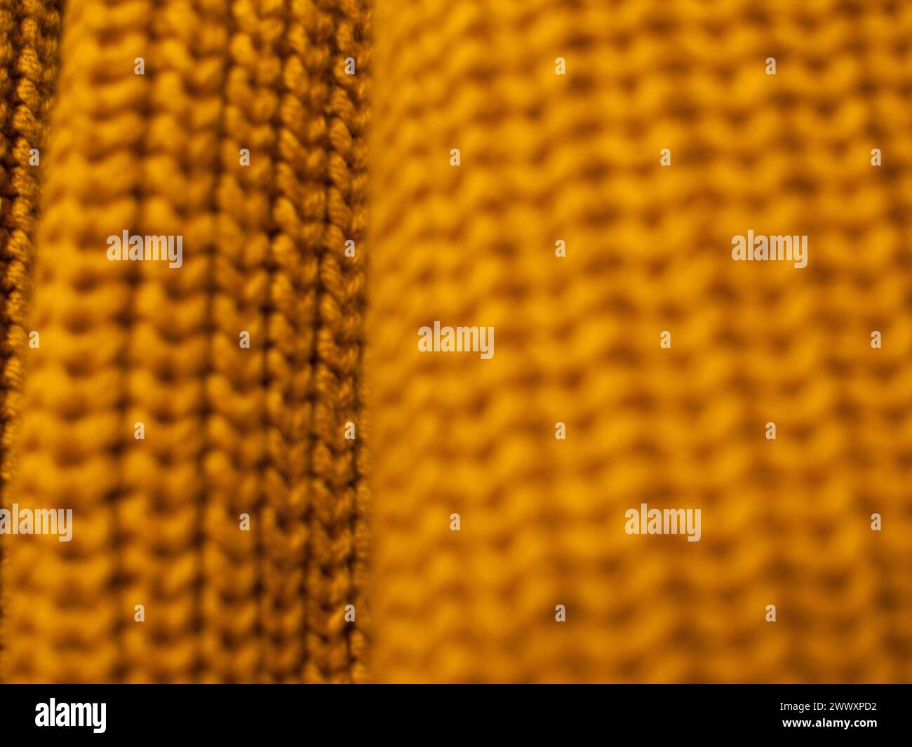 Orange textile texture with waves and negative space out of focus for ...