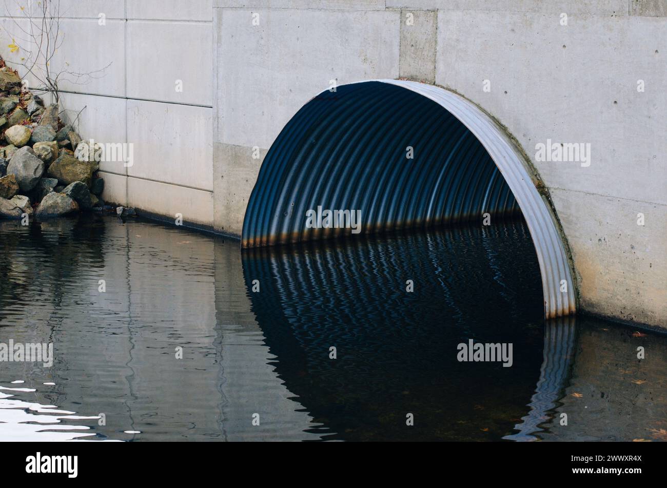 Drainage system under a highway. Metal pipe under a road Stock Photo ...