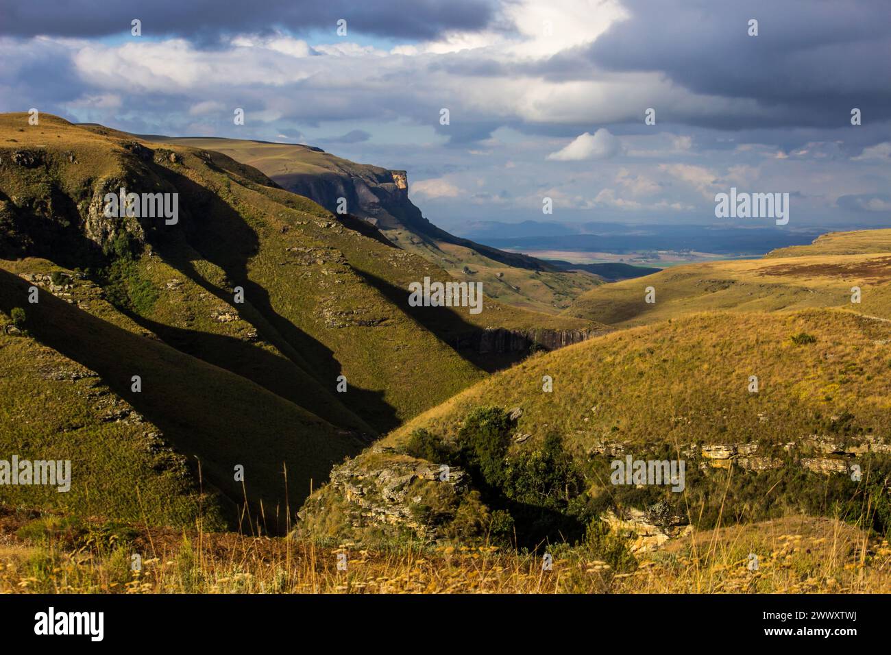 Dramatic late afternoon view of the grass covered slopes of the ...