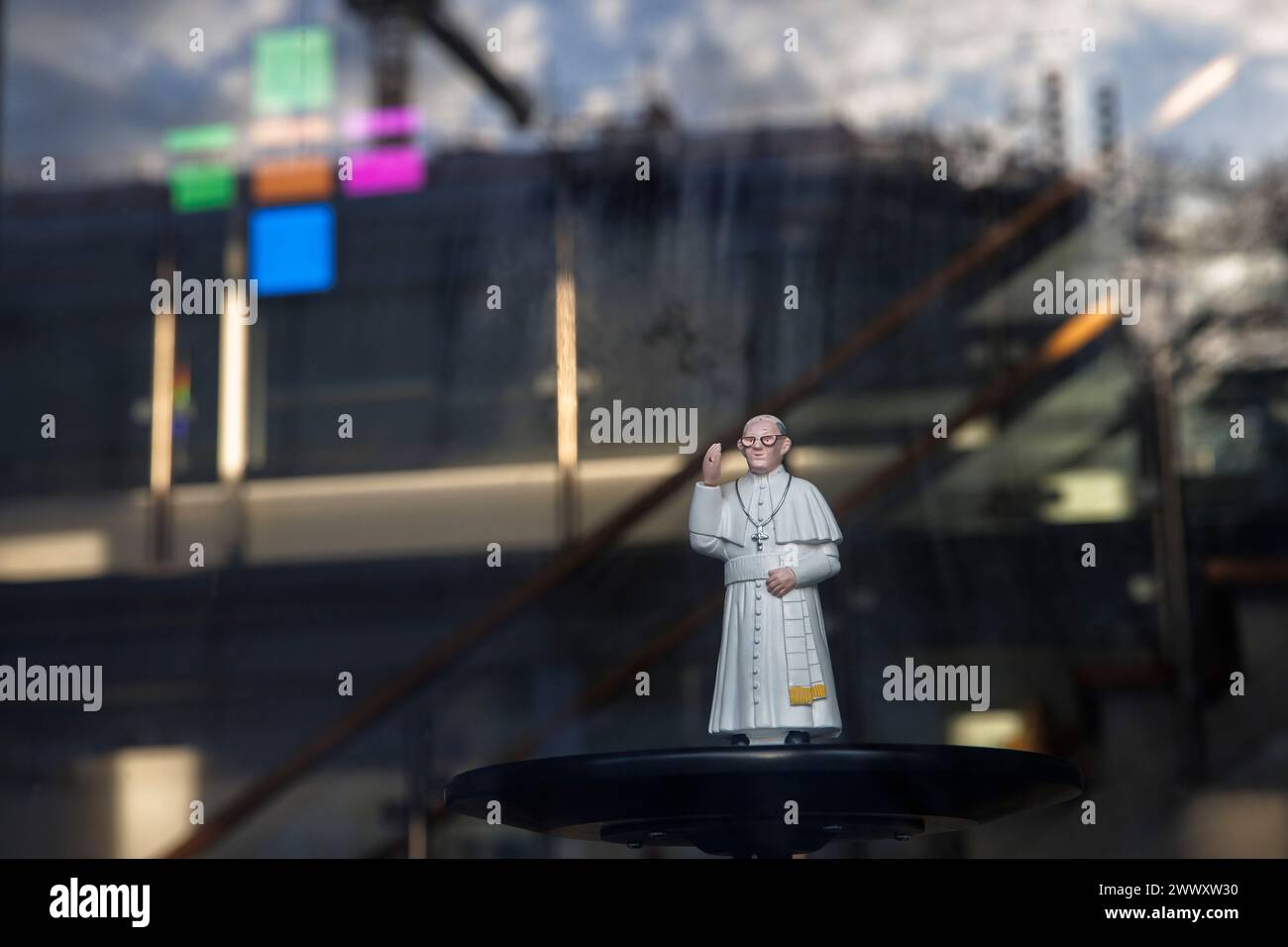 a small figurine of the pope stands in a shop window at Roncalli square ...