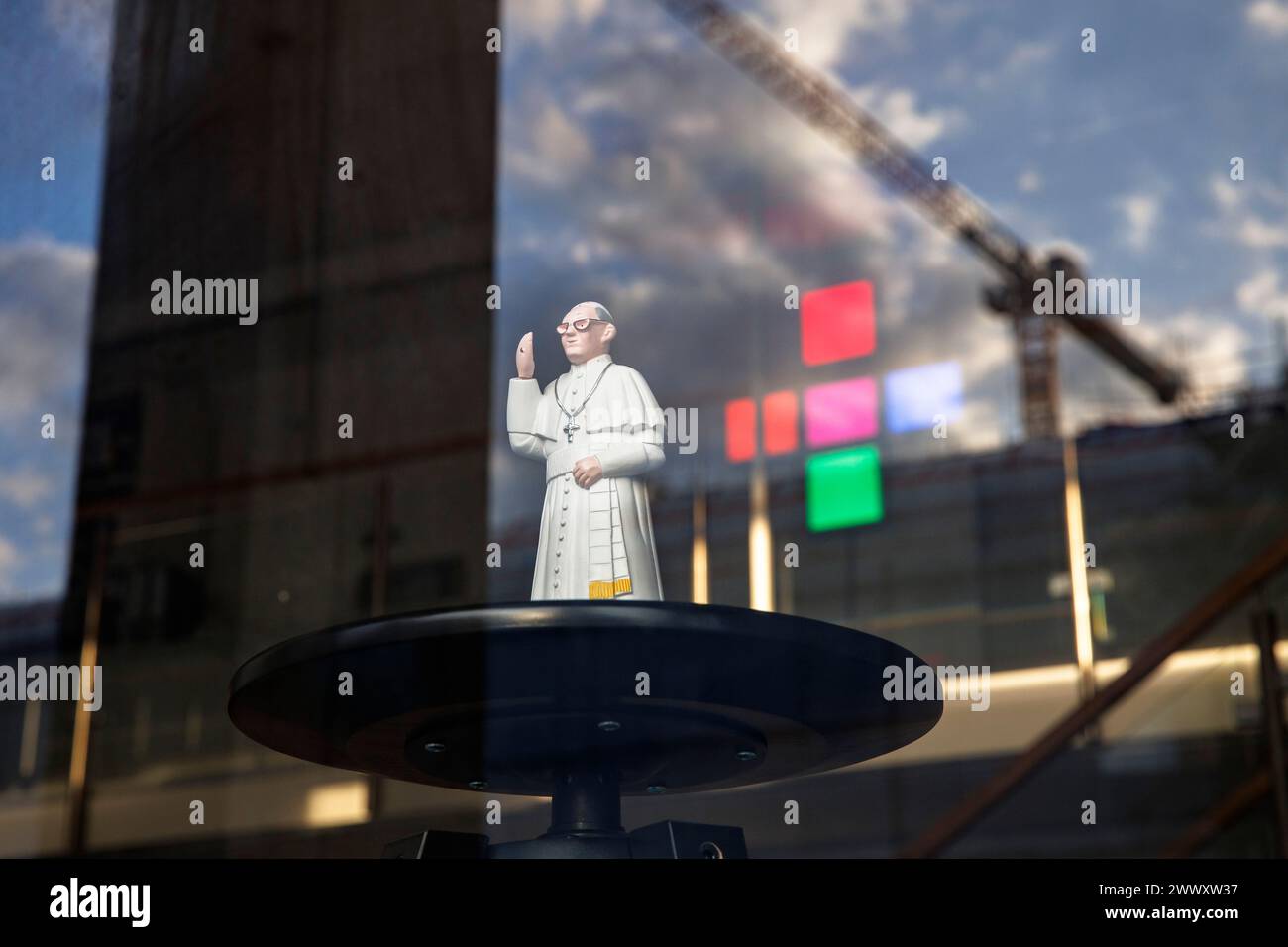 a small figurine of the pope stands in a shop window at Roncalli square ...