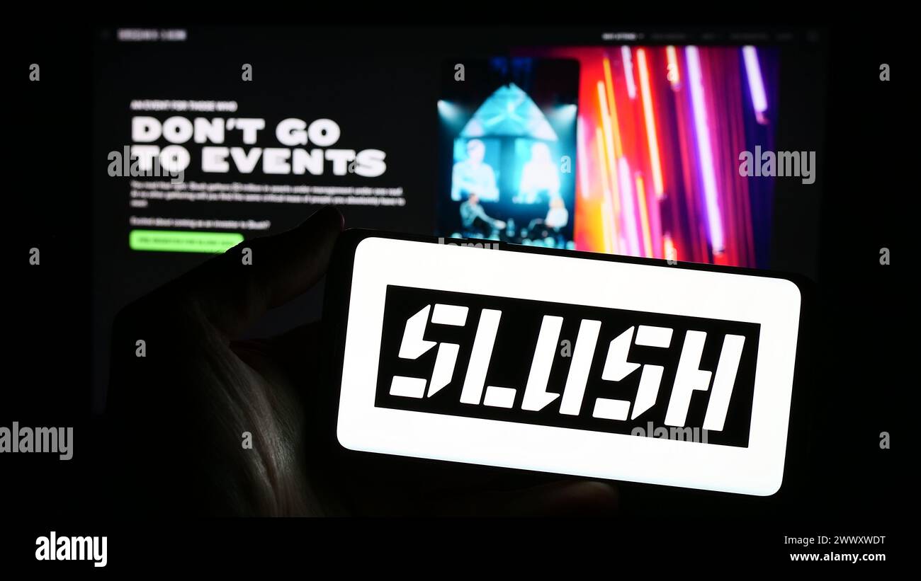 Person holding smartphone with logo of Finnish annual startup and ...