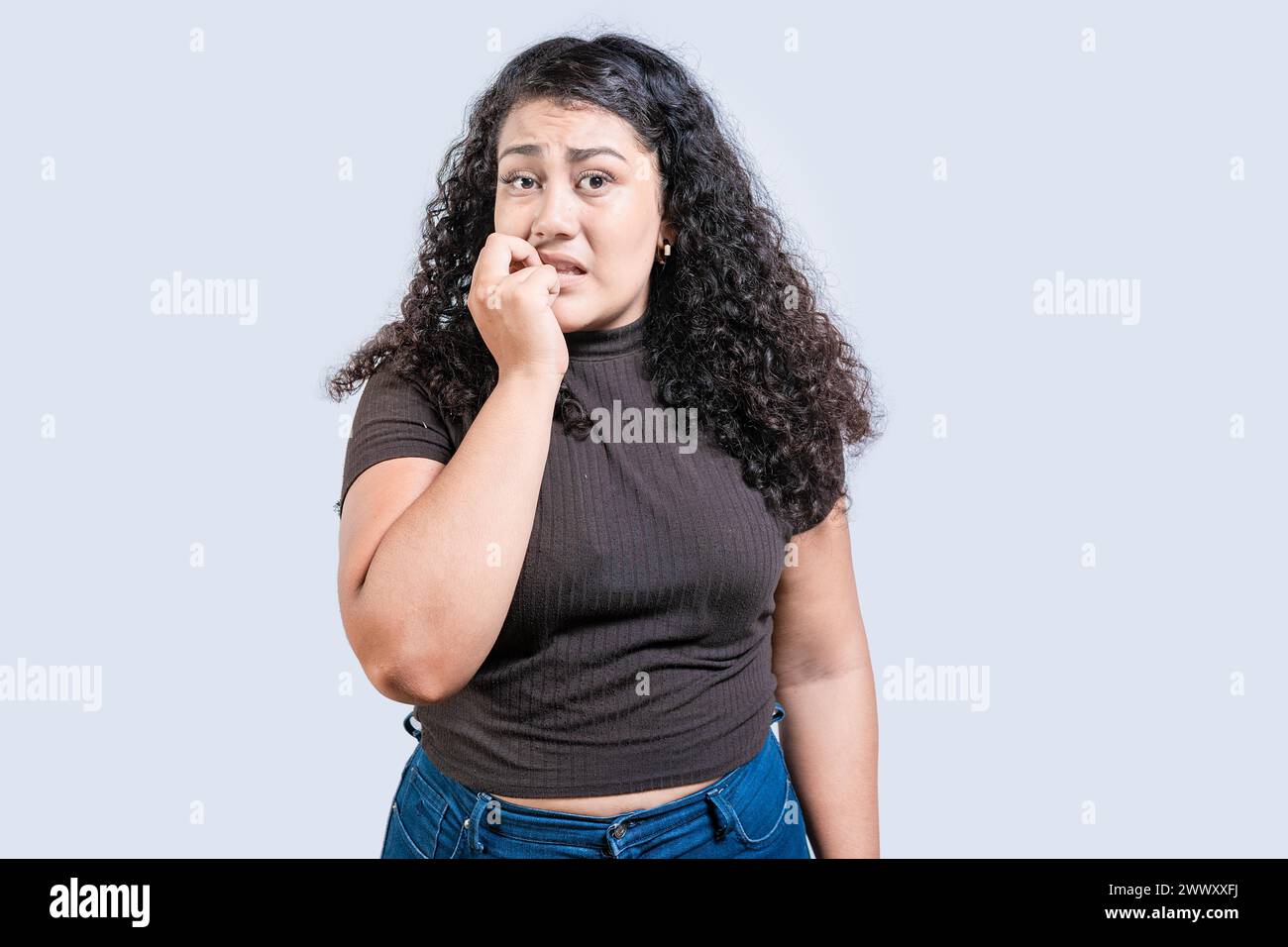 Worried girl biting her nails isolated. Insecure girl biting her nails ...